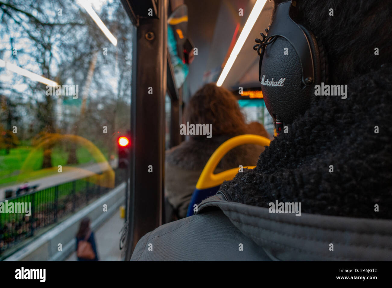 Back Of Mans Head Wearing Headphones On The Top Floor Of A Bus Stock back-of-mans-head-wearing-headphones-on-the-top-floor-of-a-bus-stock