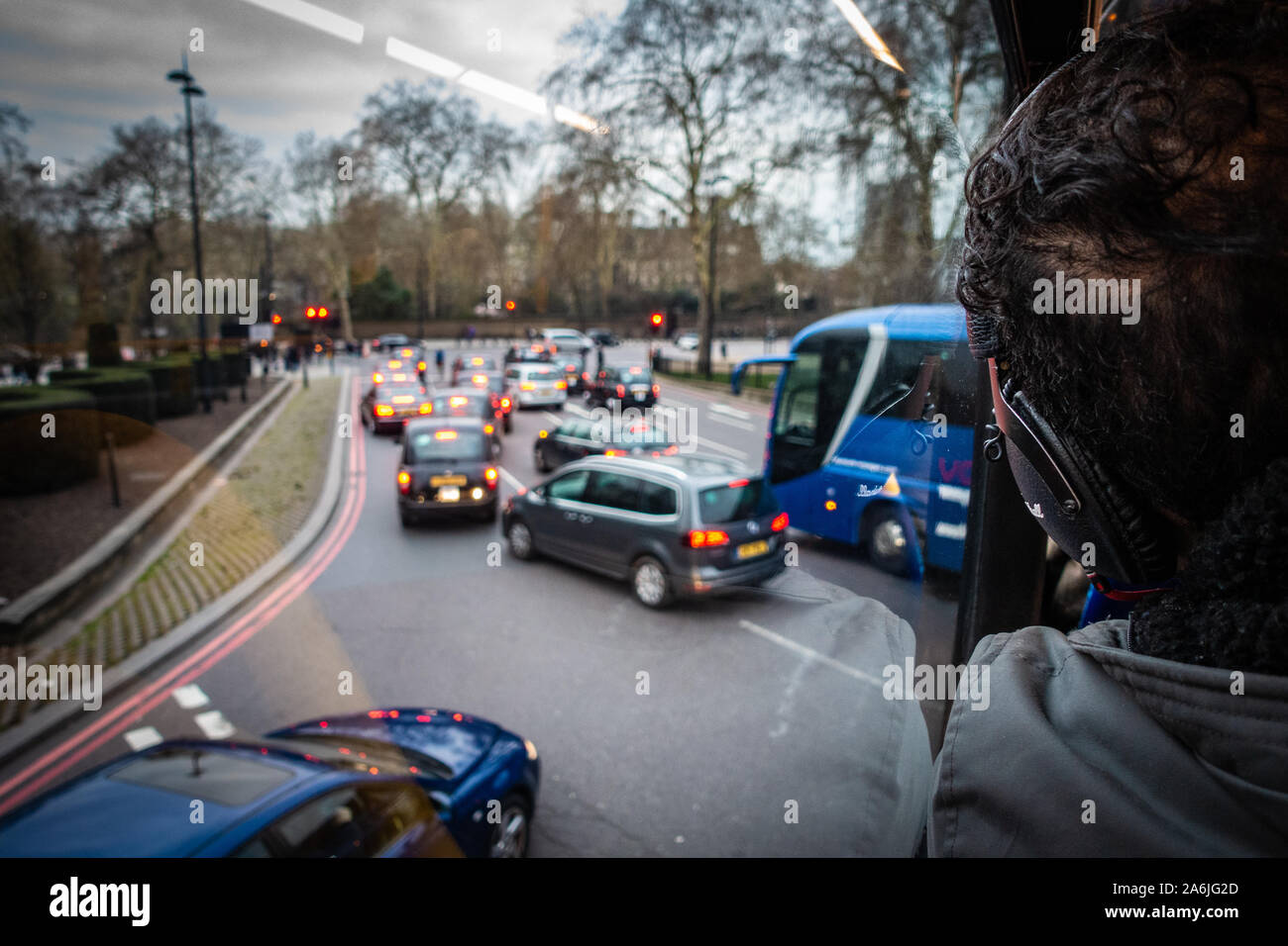 Back of mans head wearing headphones on the top floor of a bus Stock ...