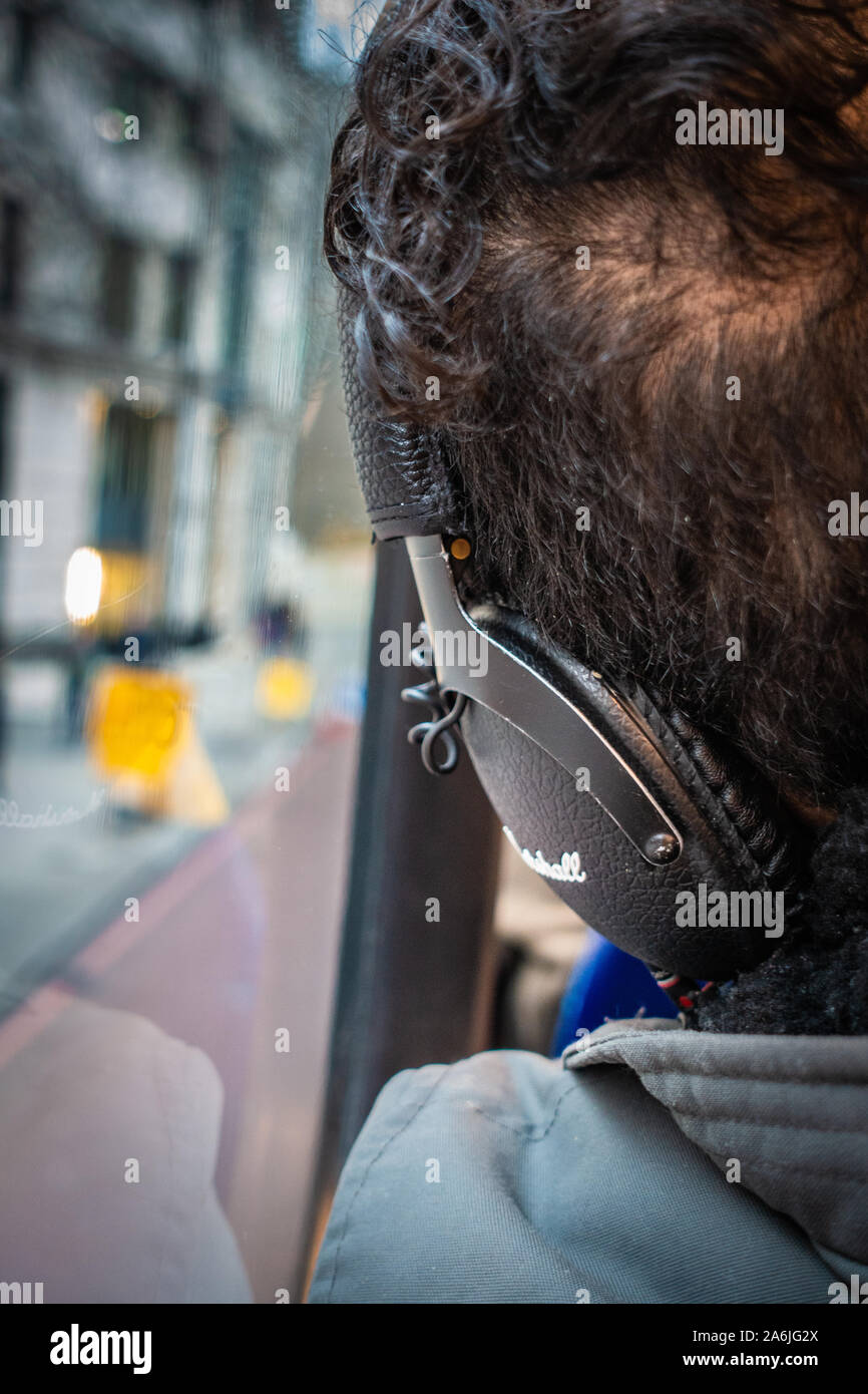 Back of mans head wearing headphones on the top floor of a bus Stock ...