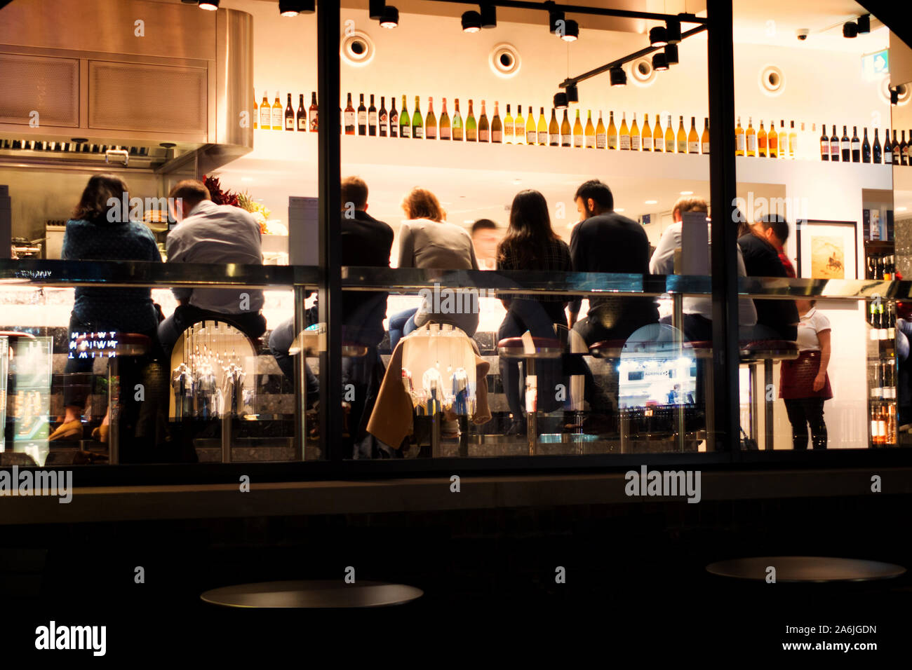 looking inside a wine bar at Coal Drops Yard seeing friends meeting up ...