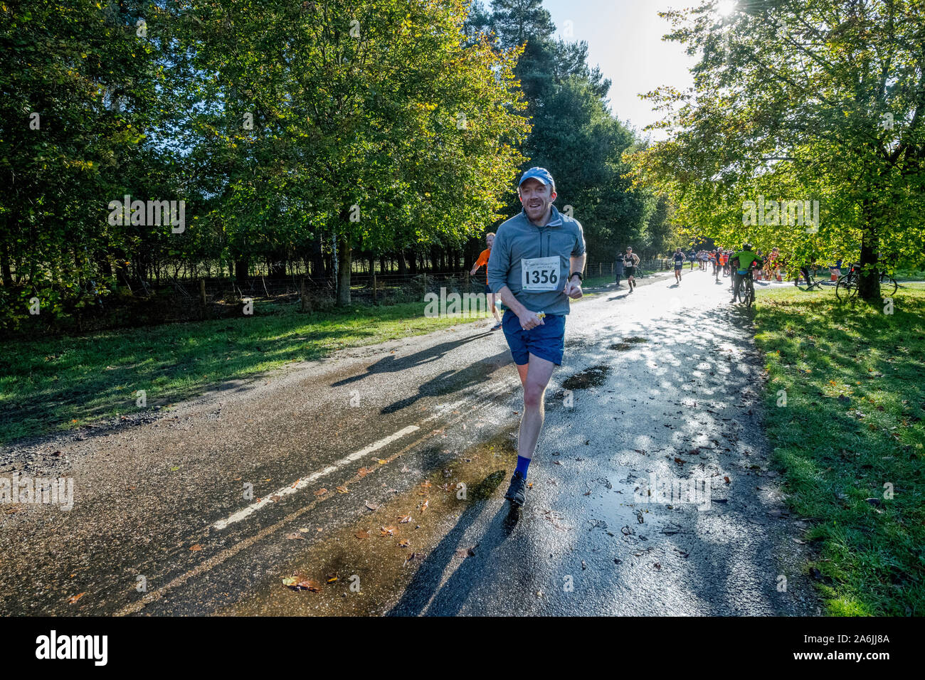 Male and female runners running in forest hi-res stock photography and ...