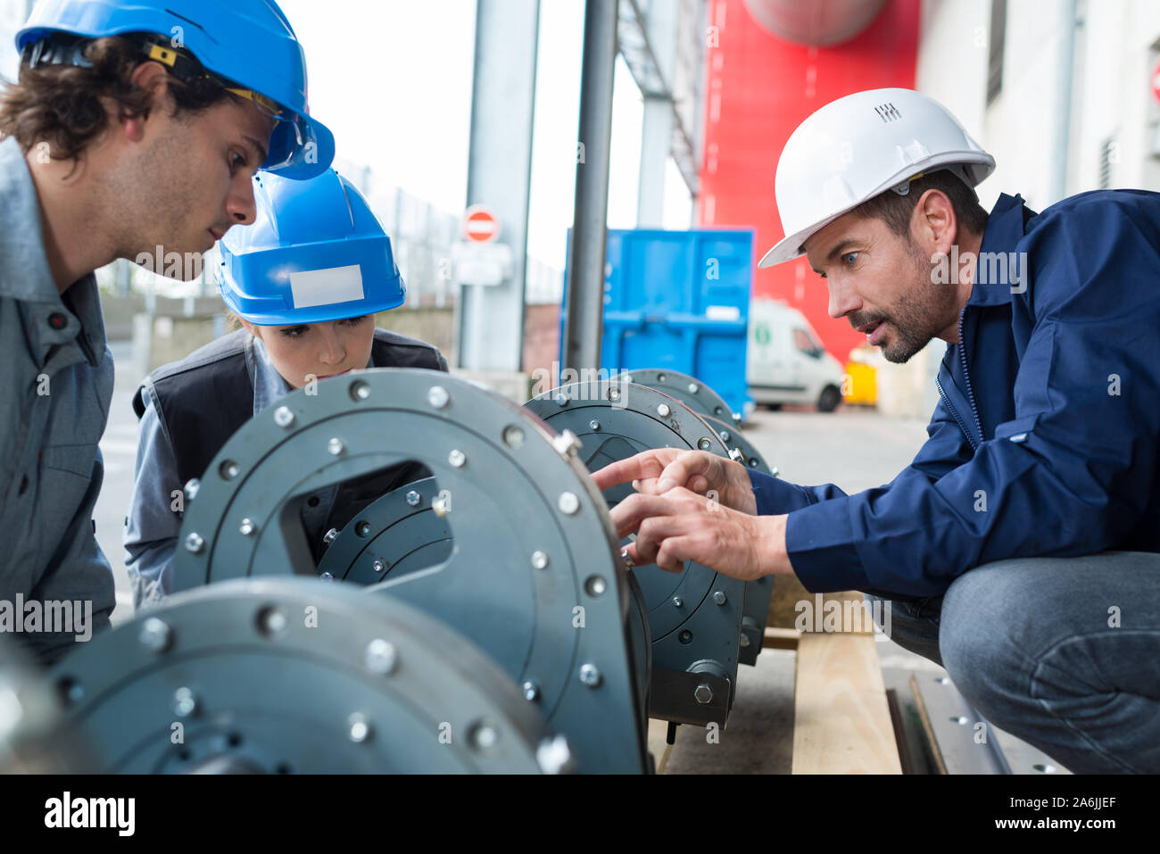 male supervisor with workers discussing in factory Stock Photo - Alamy