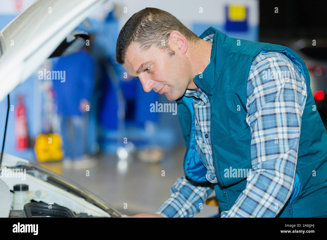 male worker checking the engine Stock Photo - Alamy