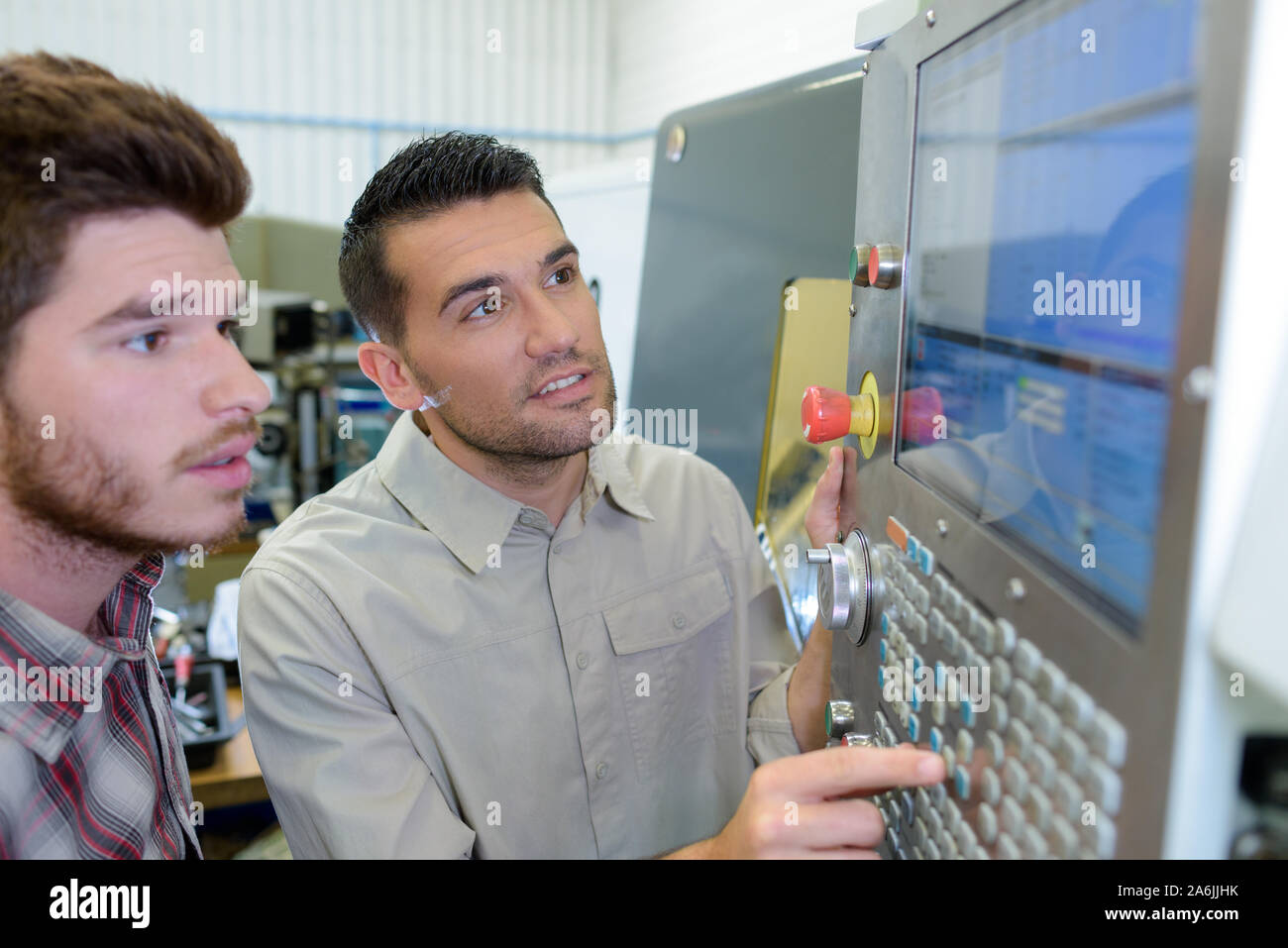 two men working with machine Stock Photo - Alamy