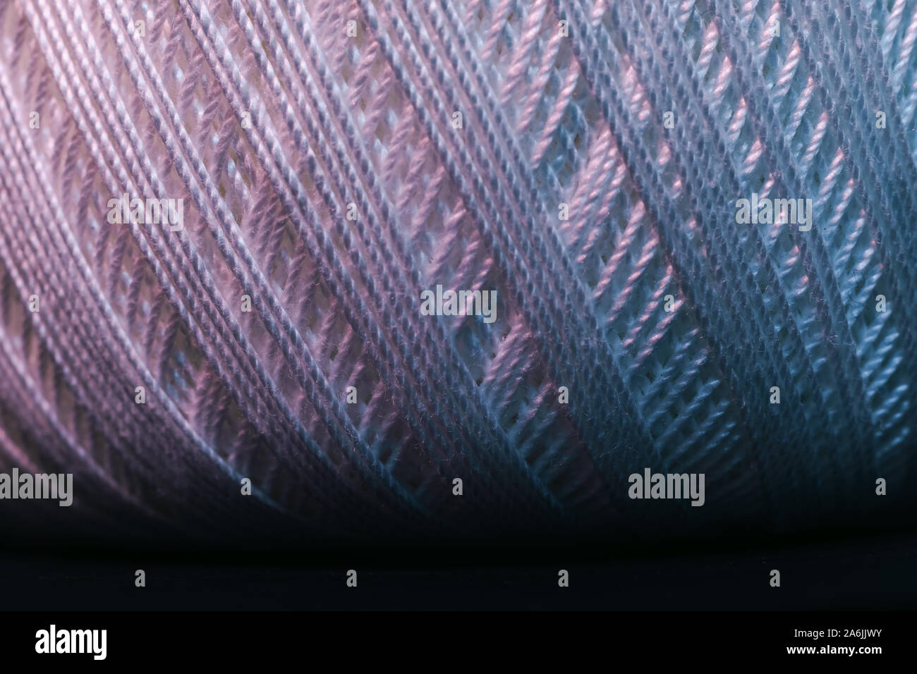 Close up beautiful white thread in red and blue light background ...