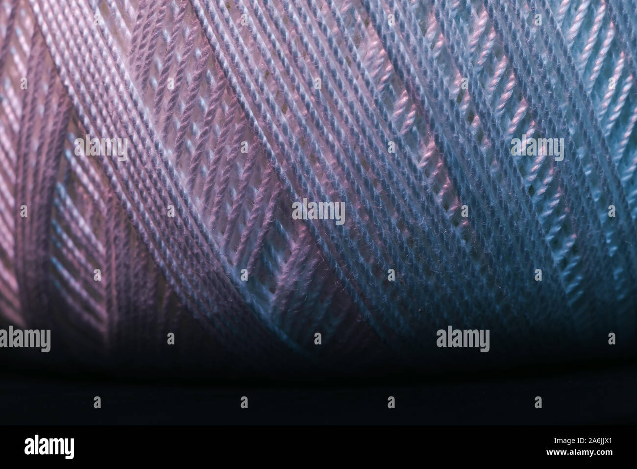 Close up beautiful white thread in red and blue light background ...