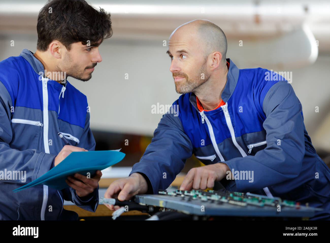two mechanics are working together Stock Photo - Alamy