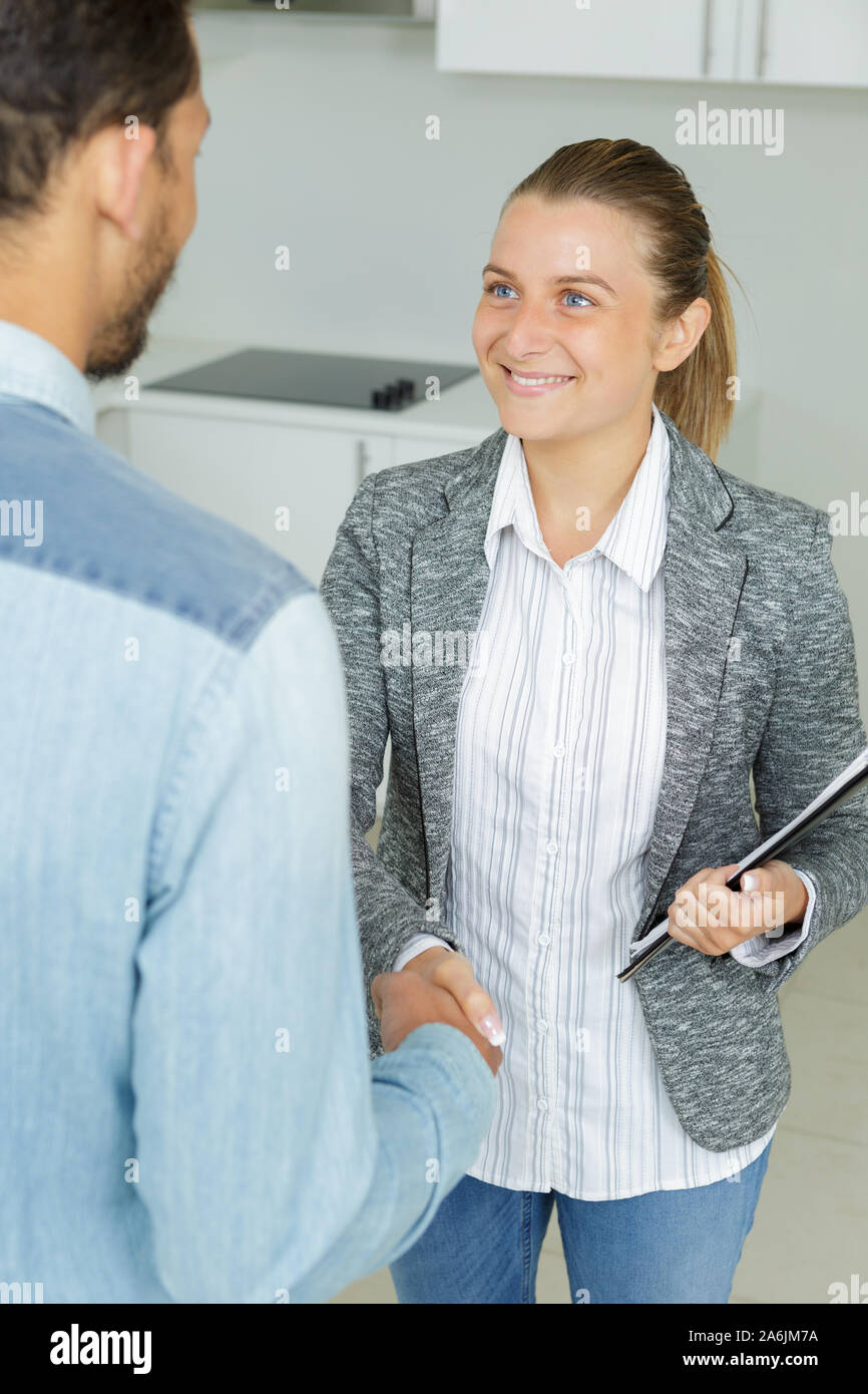 female property agent greeting client with a handshake Stock Photo - Alamy