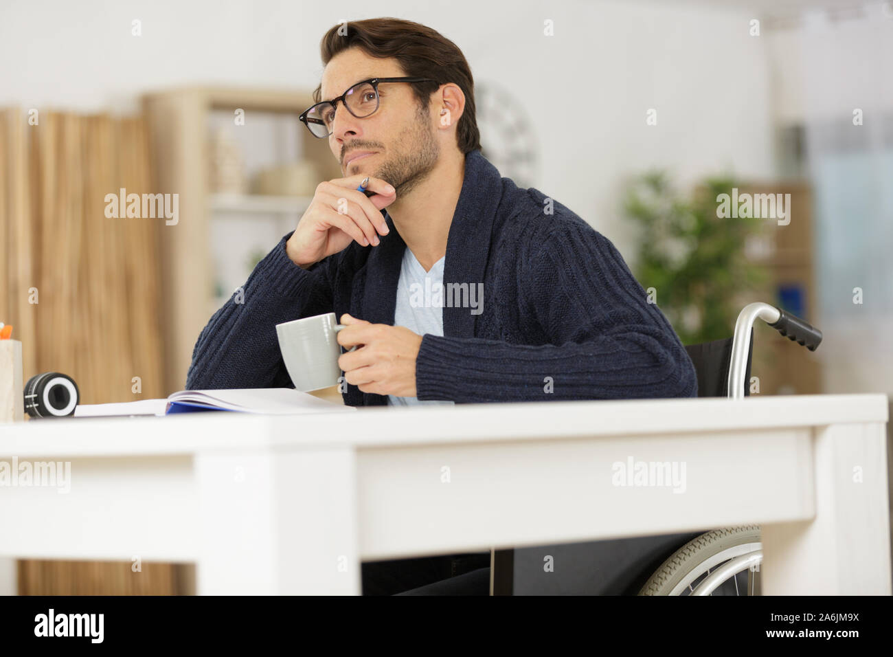 handsome disable man thinking at home Stock Photo - Alamy