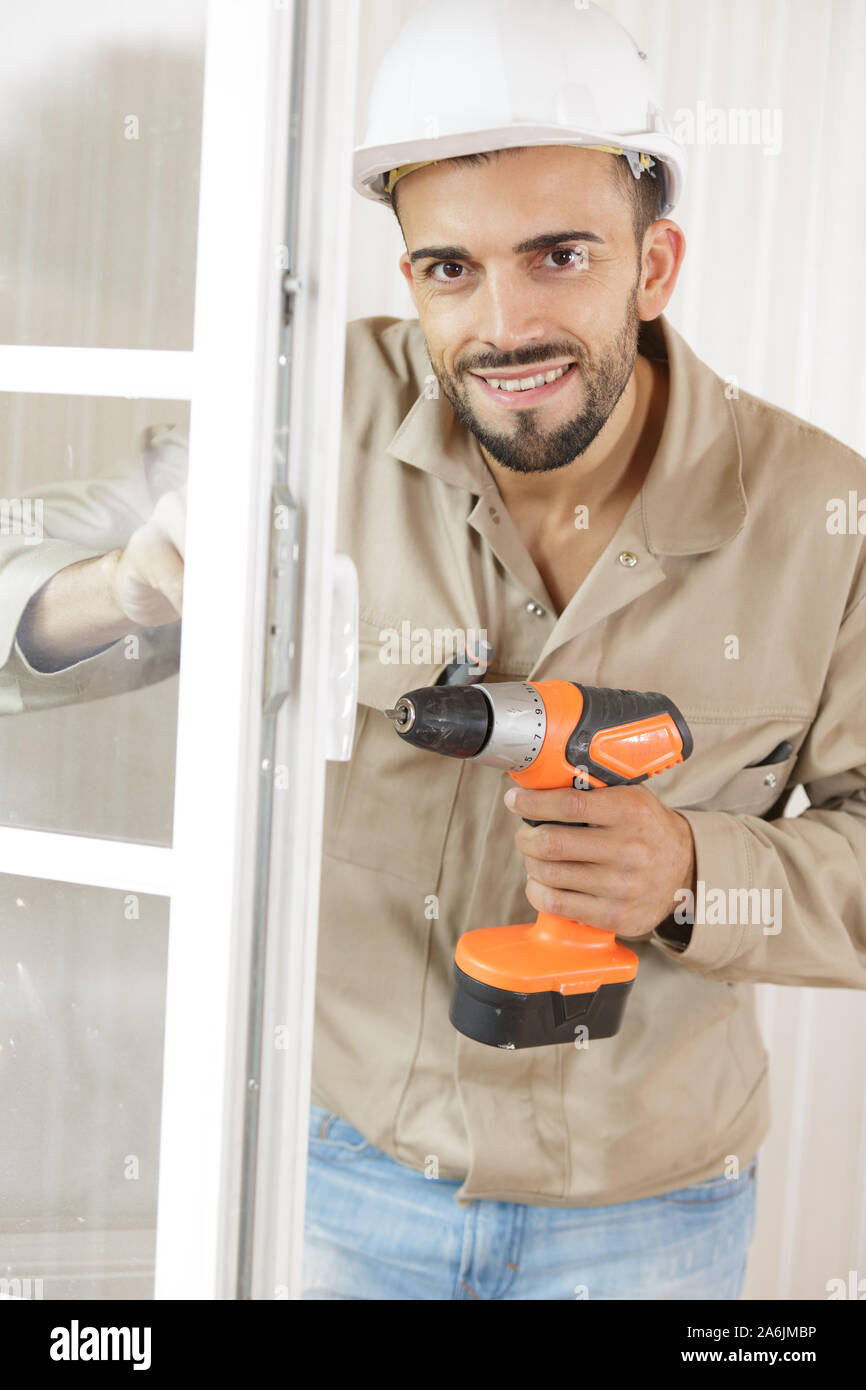 a man drilling window frame Stock Photo - Alamy