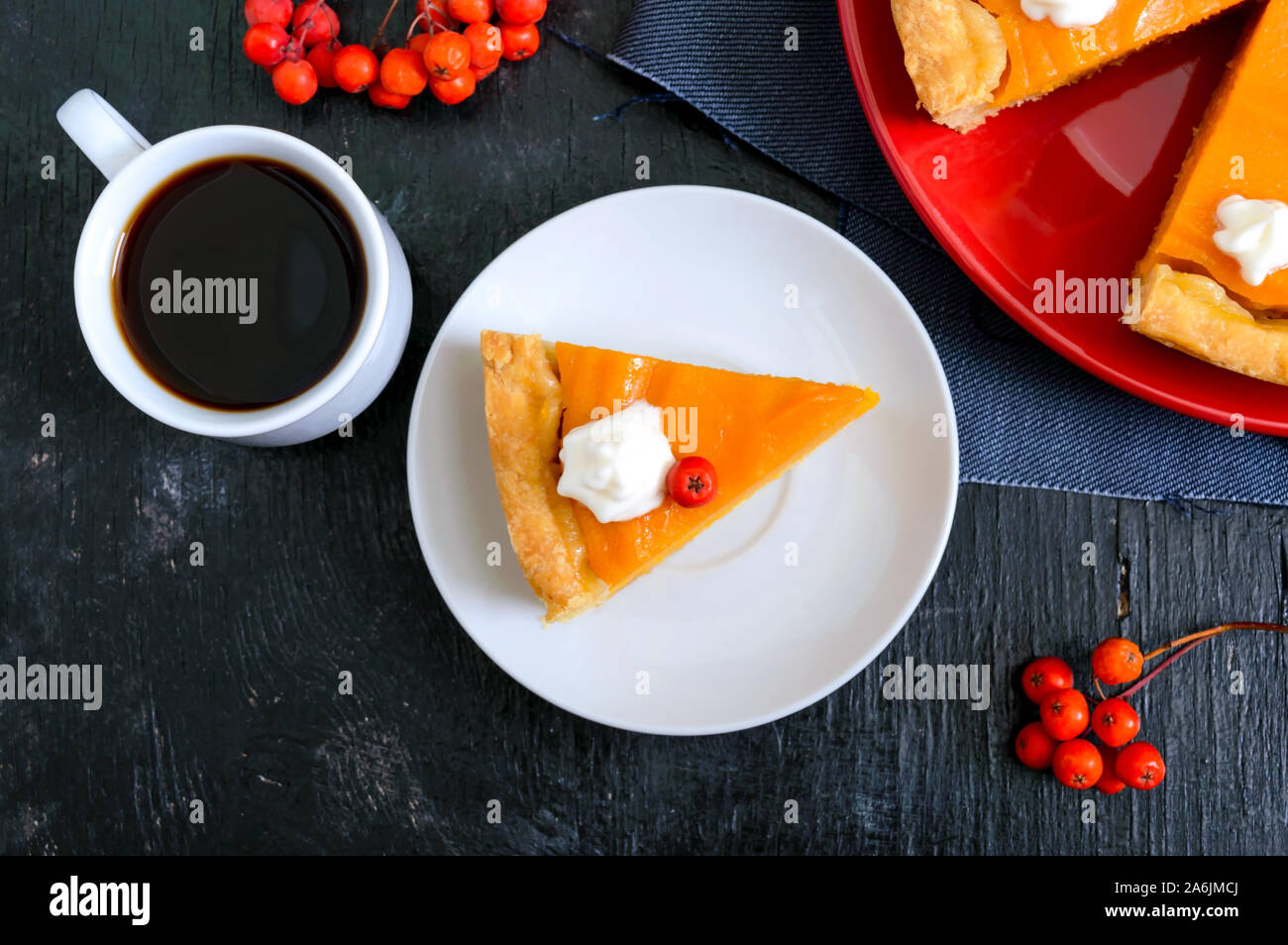 Piece of traditional homemade pumpkin pie and a cup of coffee on a ...