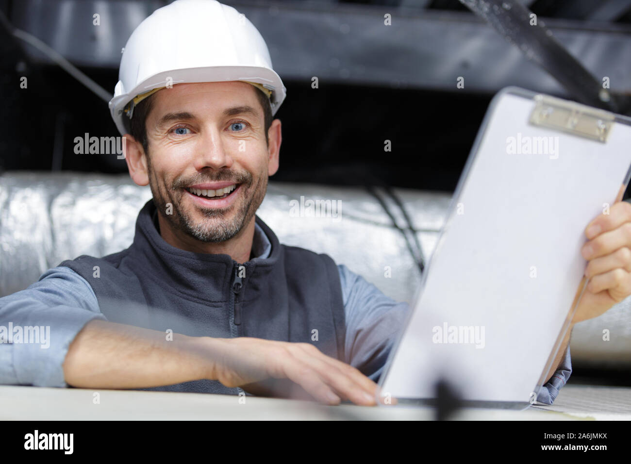 happy male worker holding a clipboard Stock Photo - Alamy