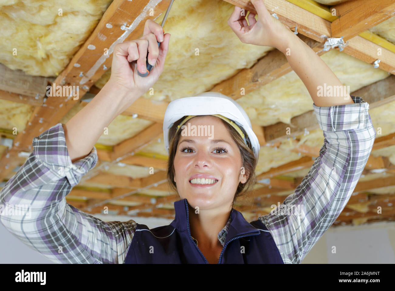 happy electrician installing ceiling lights in domestic home Stock ...