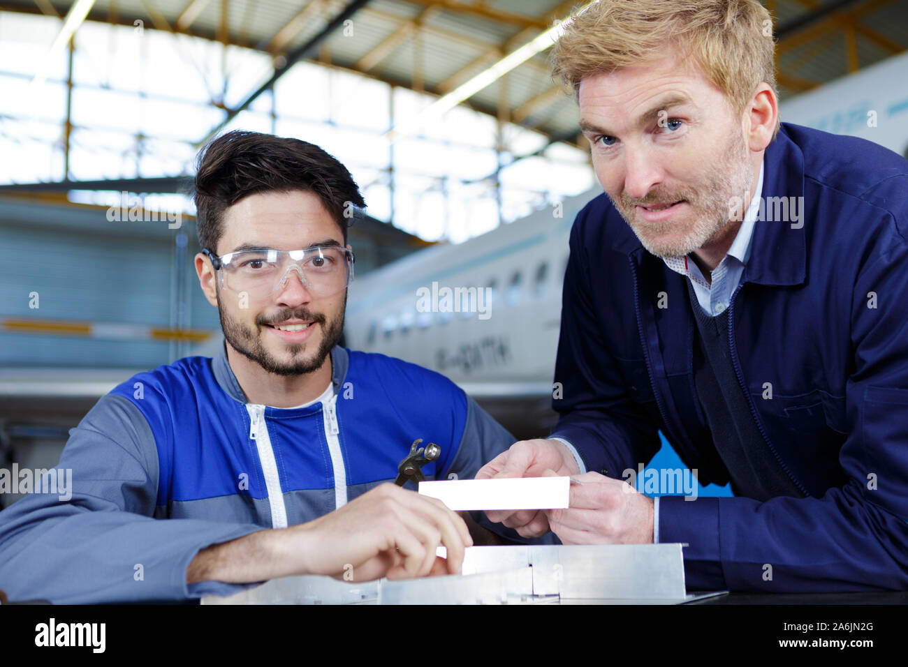 two workers working in factory Stock Photo - Alamy