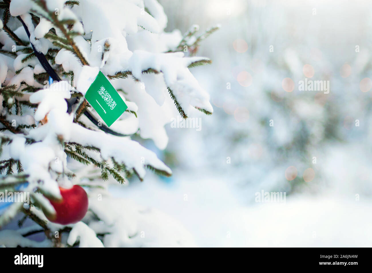 Christmas Saudi Arabia. Xmas tree covered with snow, decorations and a ...