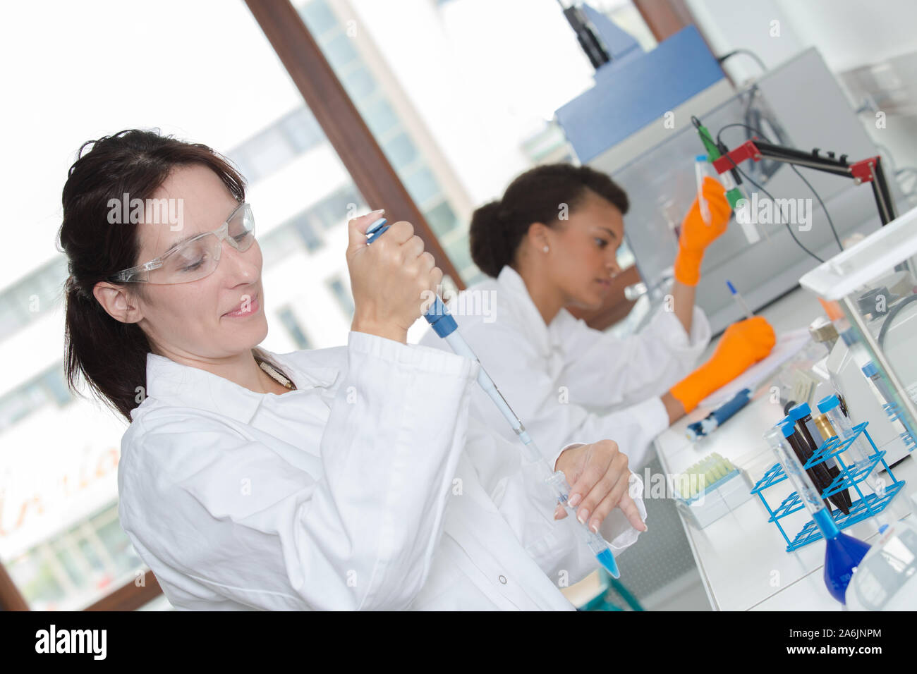 Woman using pipette in laboratory Stock Photo - Alamy