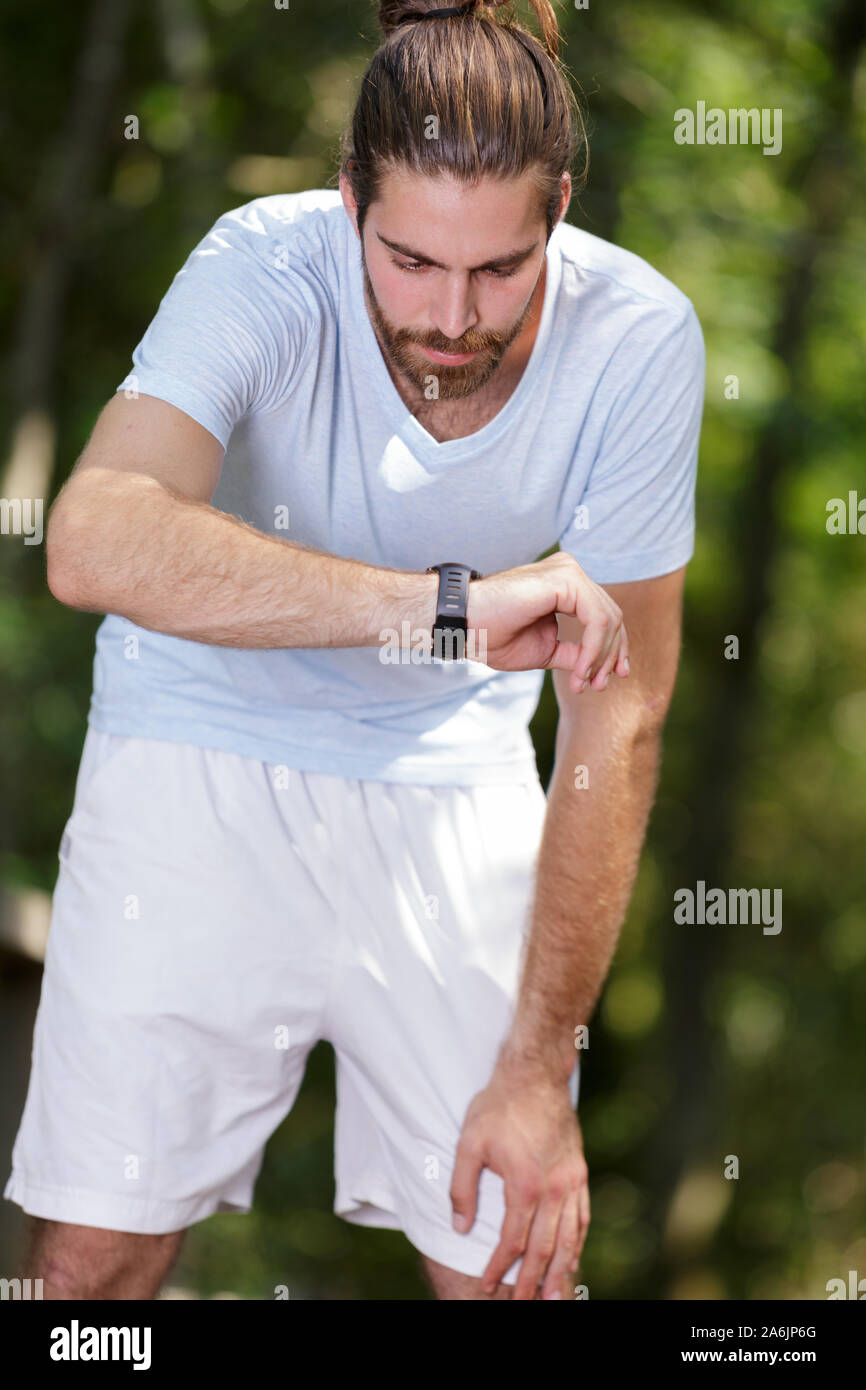 a man checking his stopwatch Stock Photo - Alamy