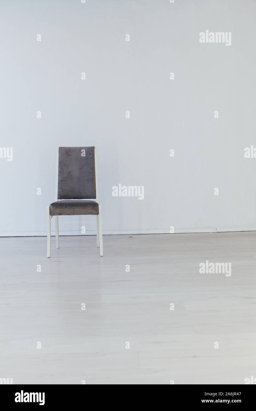 one gray vintage chair in an empty white room Stock Photo - Alamy