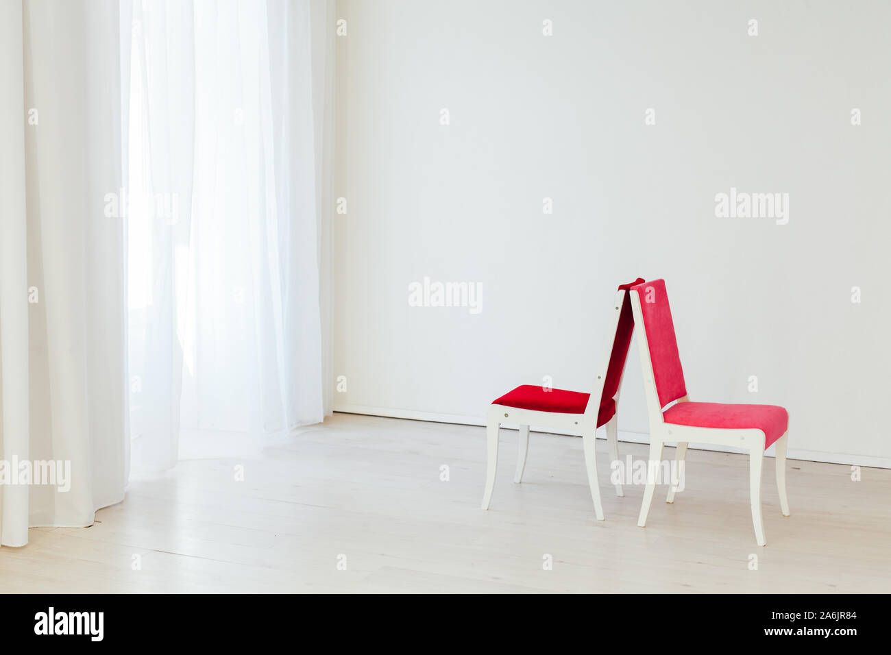 two vintage chairs in an empty white room Stock Photo - Alamy