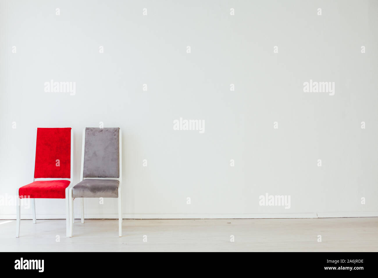 two vintage chairs in an empty white room Stock Photo - Alamy