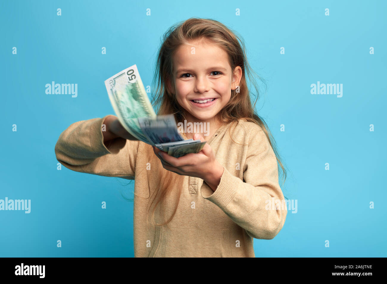 rich girl concept. smiling cheerful girl donets money on stray animals ...