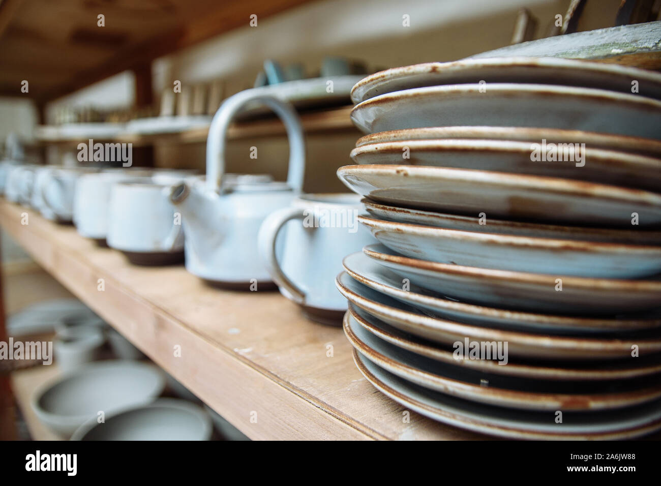Interesting handmade ceramic plates on the shelf of the Potter's ...