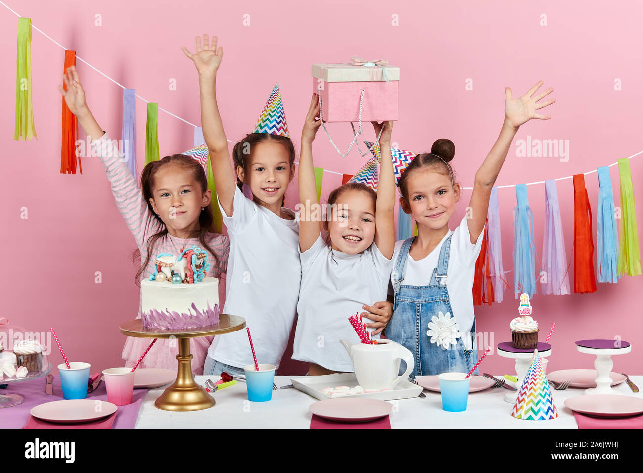 positive cute girls raising their arms celebrating birthday, isolated ...