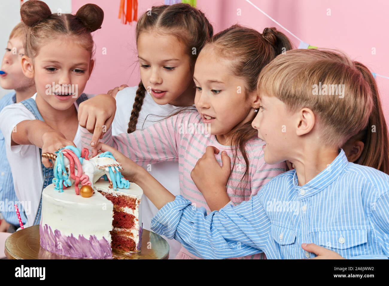 little cute children eating cake with fingers. close up photo. isolated ...