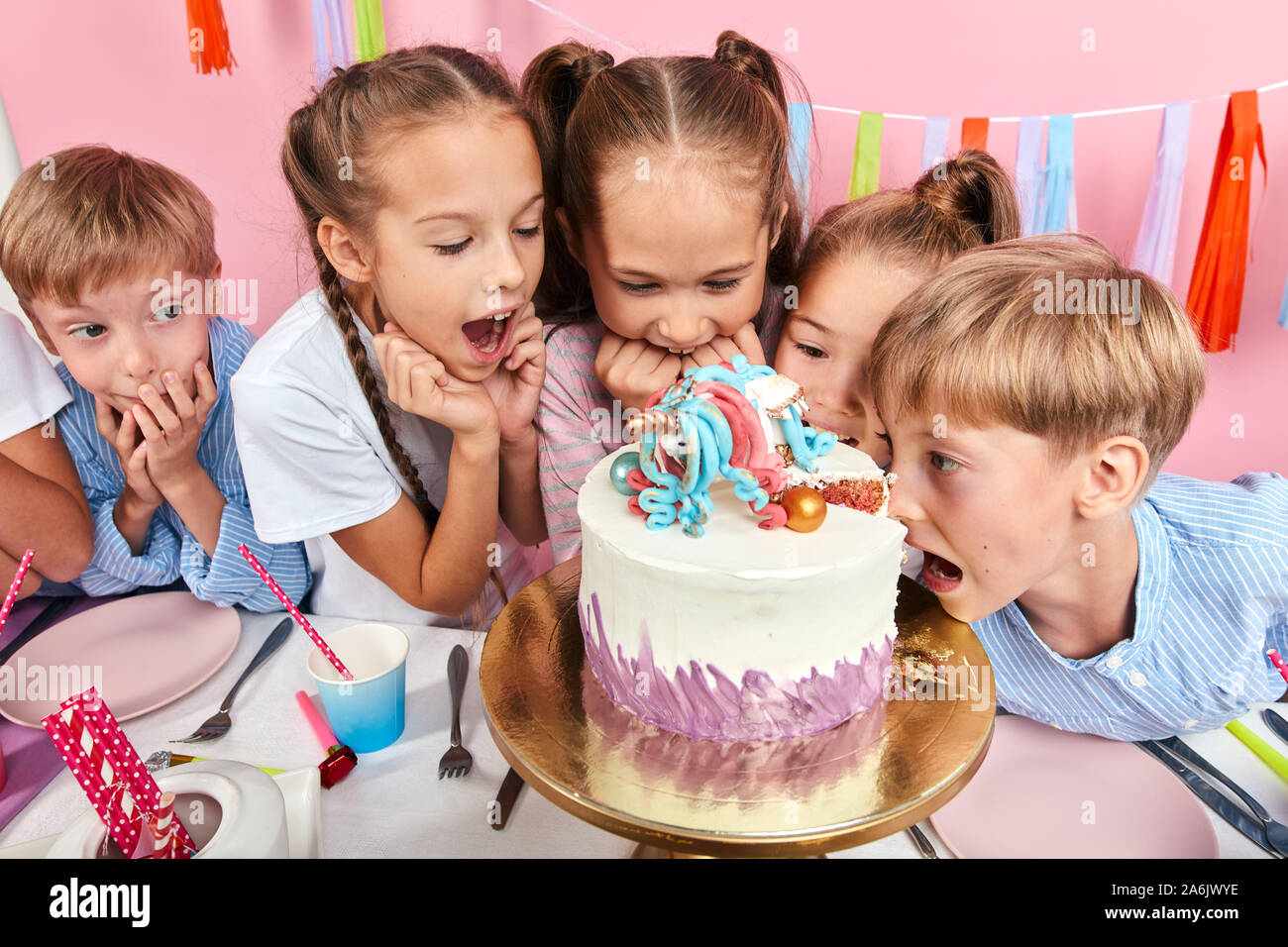 shocking children standing at the table. sincere emotions. isolated ...