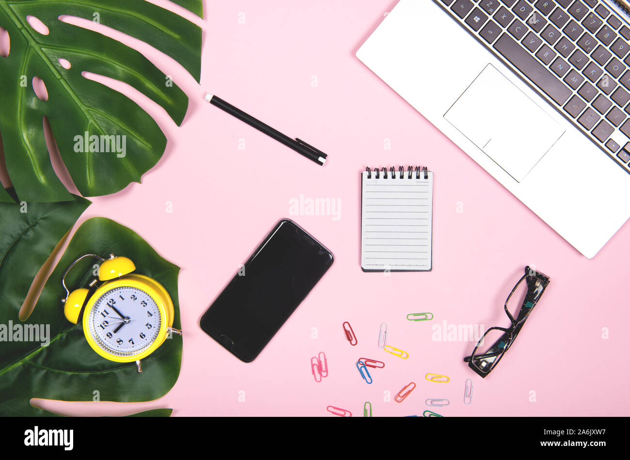 Office workplace with laptop computer, daily planner, phone, pen and ...