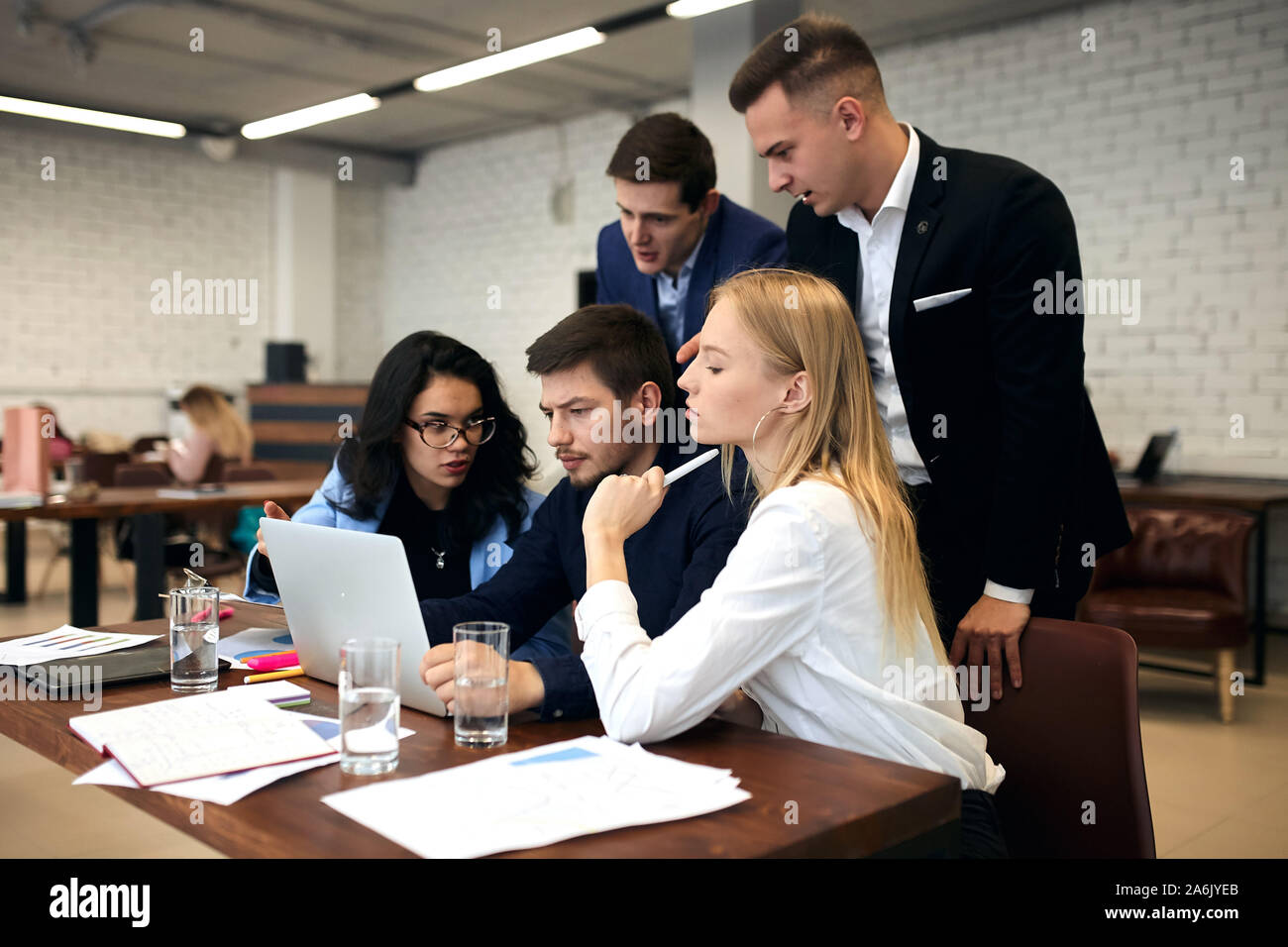 young people in elegant suits working with laptop in the mordern room ...