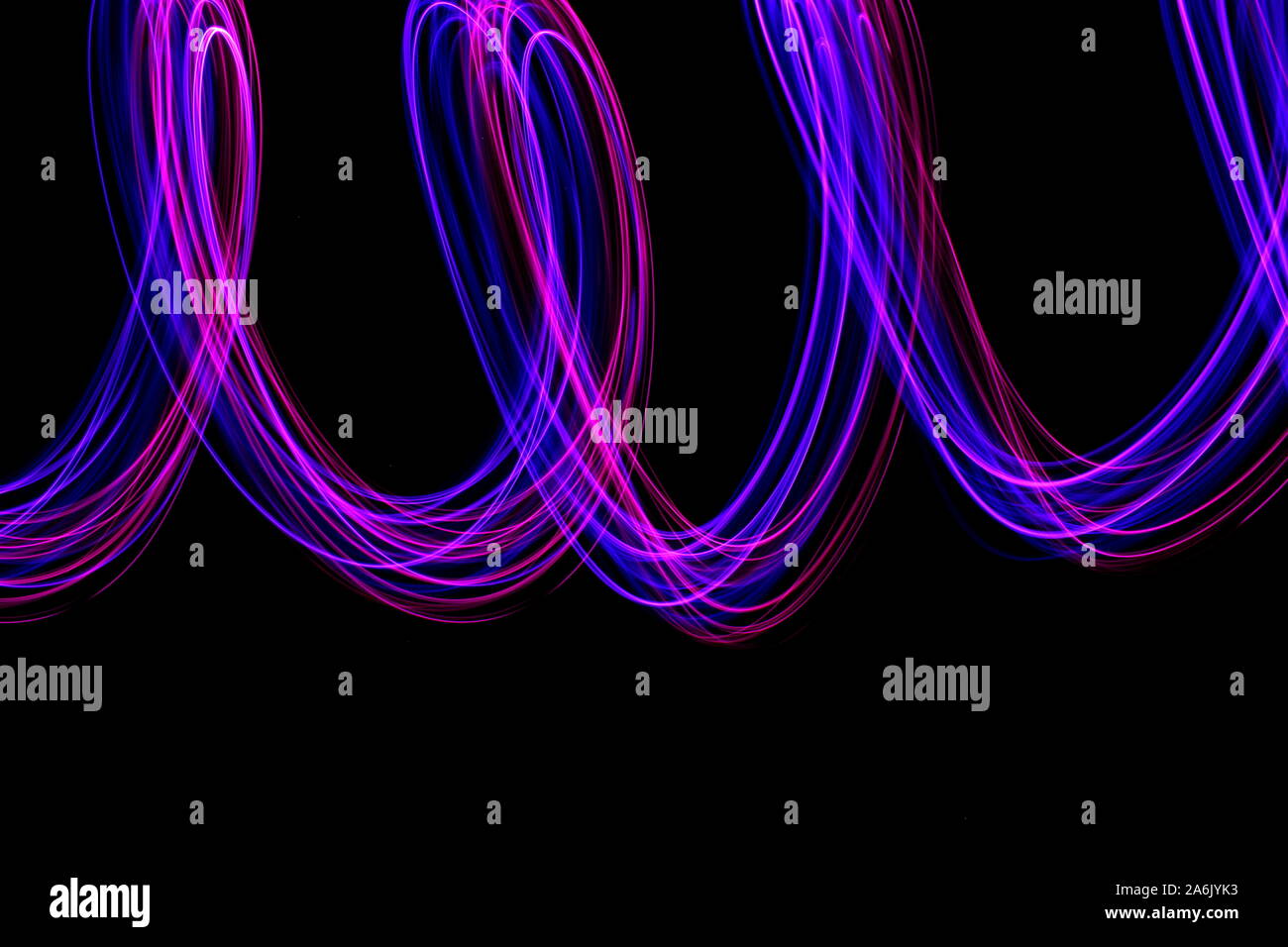 Long exposure photograph of neon colour in an abstract swirl, parallel ...