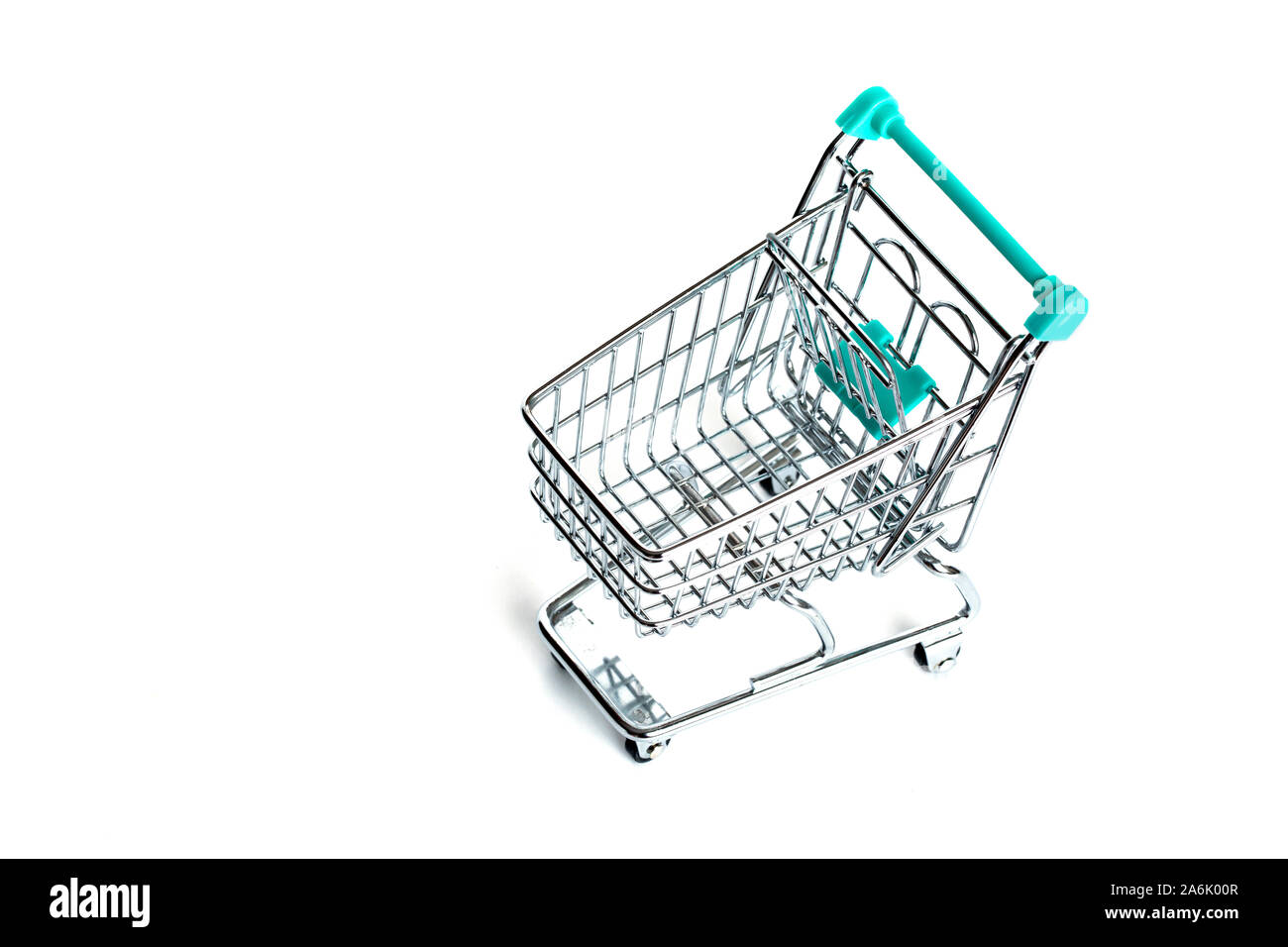 Miniature empty shopping cart turquoise color on white background ...