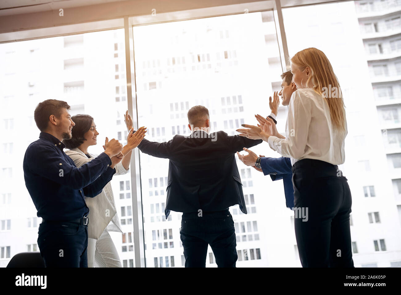 cheerful friendly colleagues greeting, congratulating their new leader ...