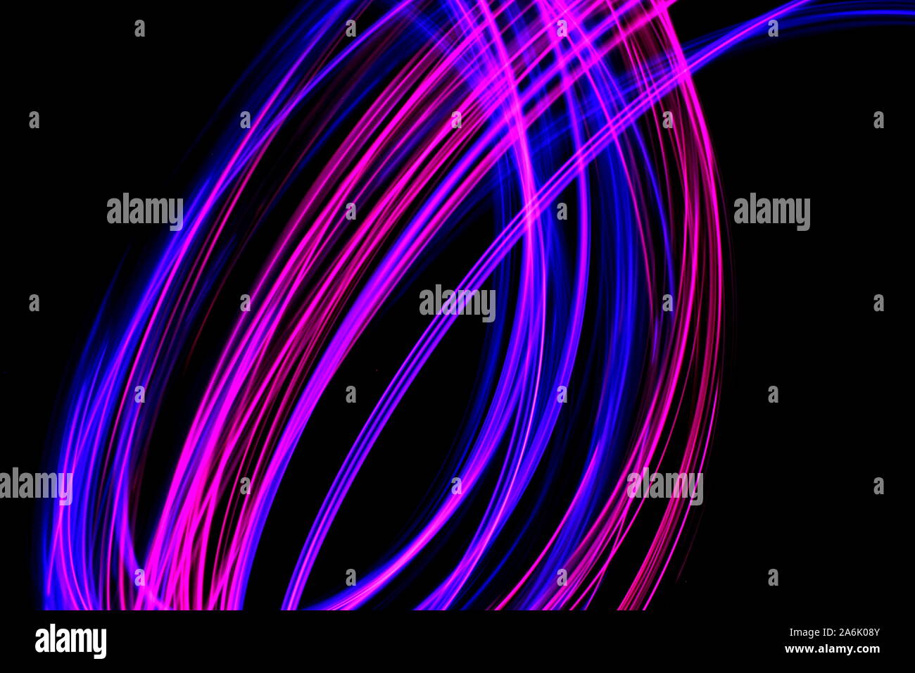 Long exposure photograph of neon colour in an abstract swirl, parallel ...