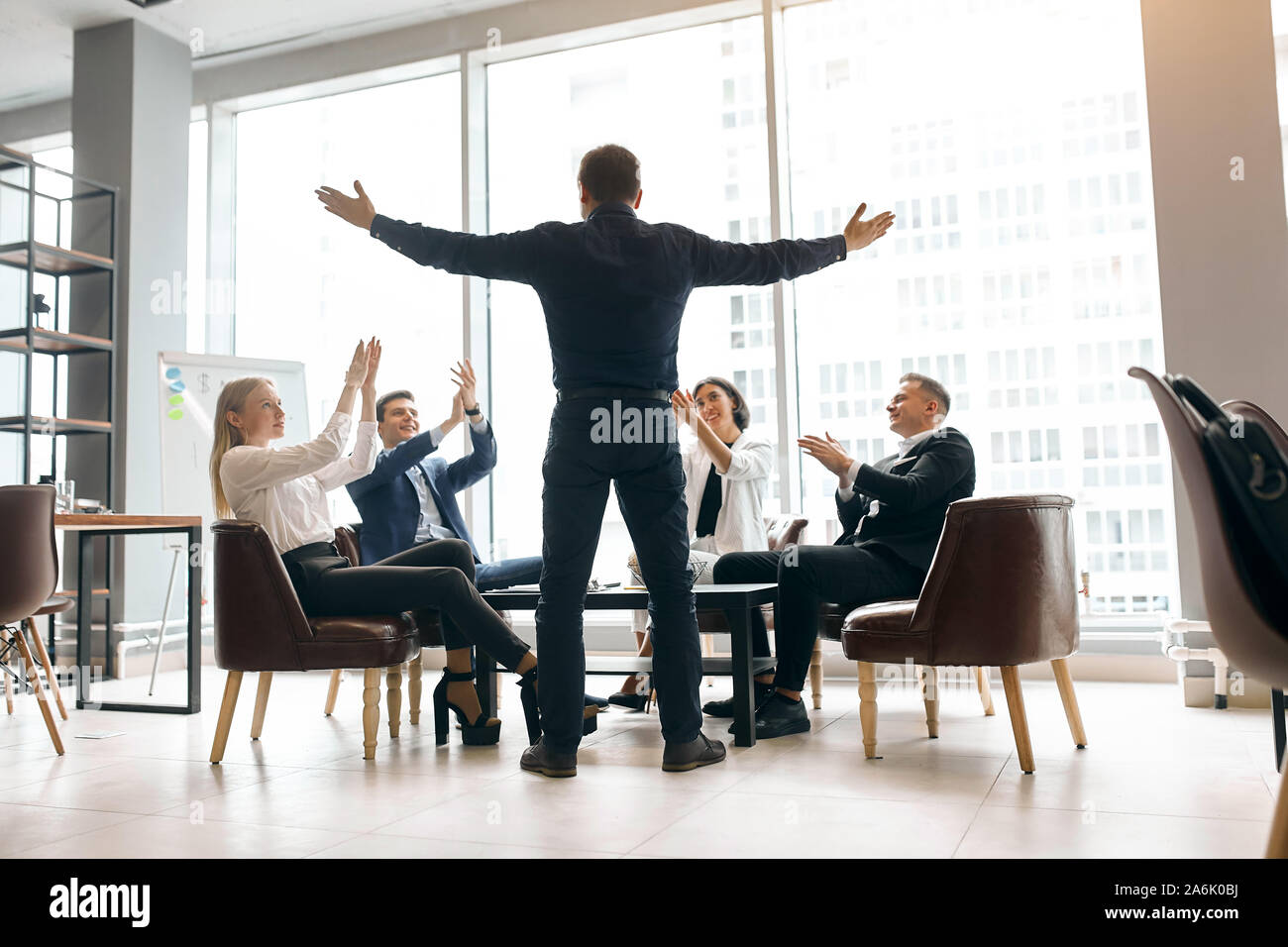 cheerful friendly colleagues greeting new employee, congratulating ...