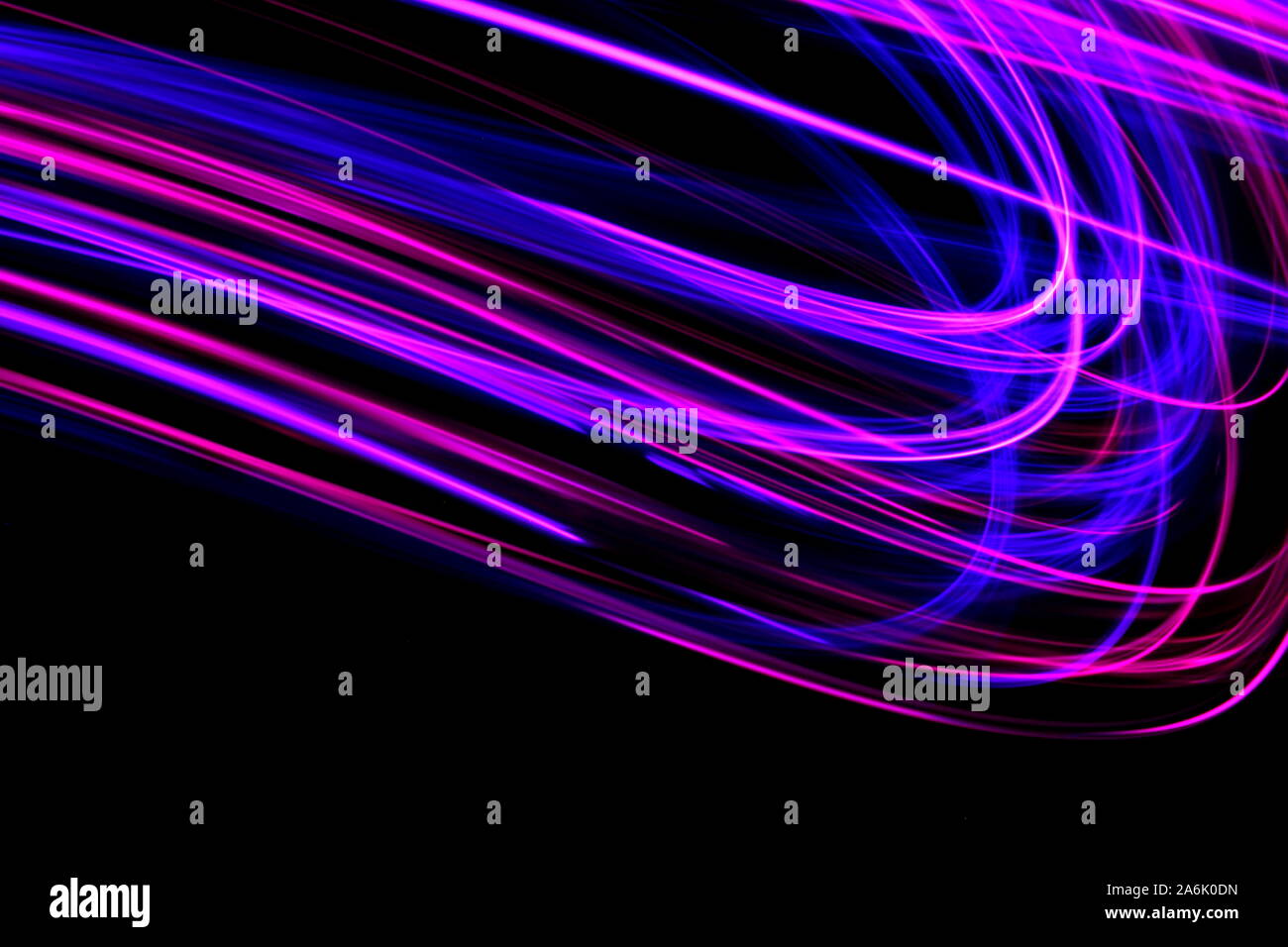 Long exposure photograph of neon colour in an abstract swirl, parallel ...