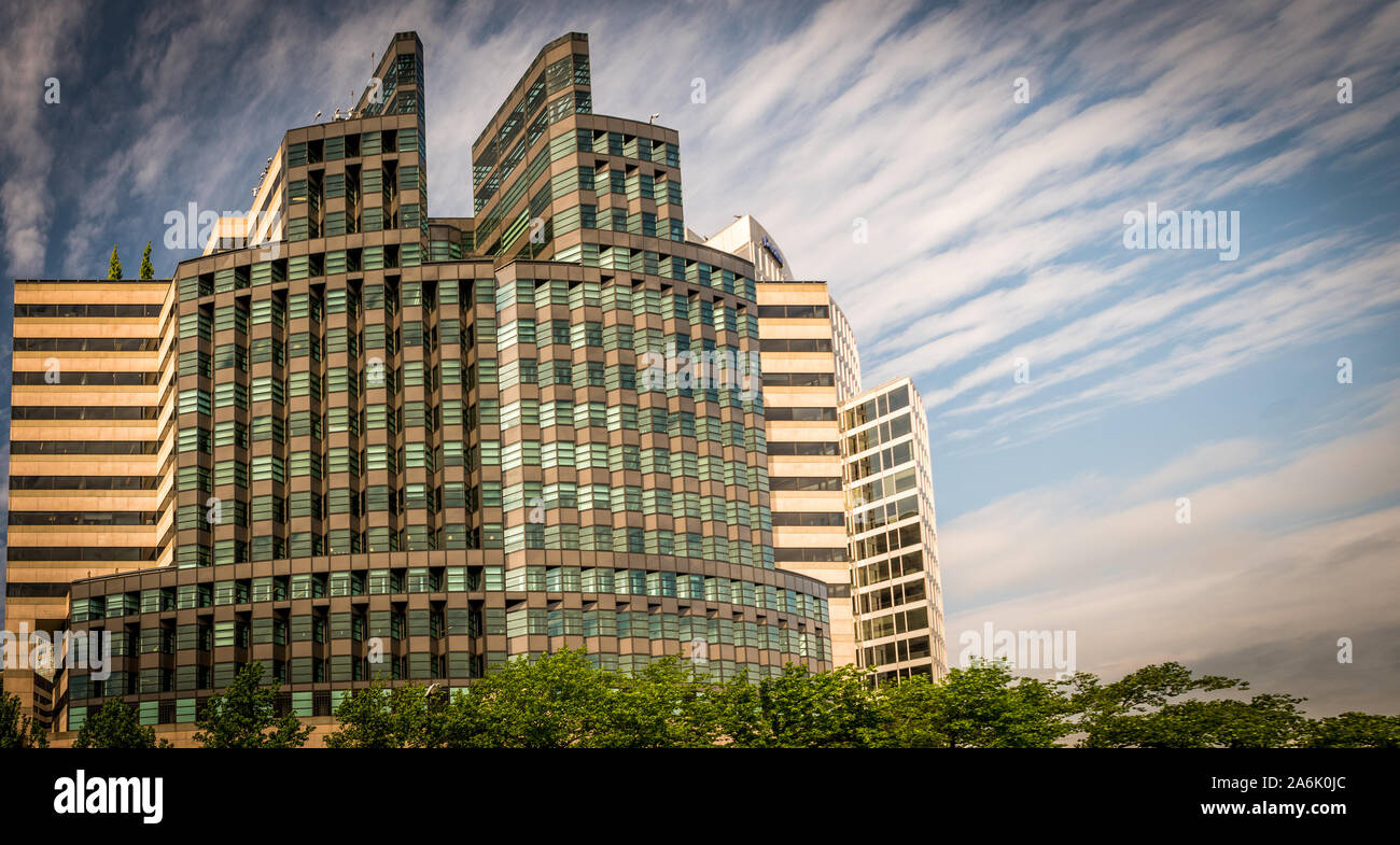 A group of large office buildings with sky and blue sky in the ...