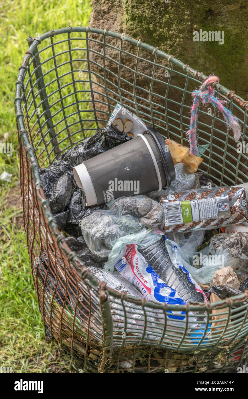 Trash bin / rubbish bin / litter bin in UK public park. Disposable cups ...