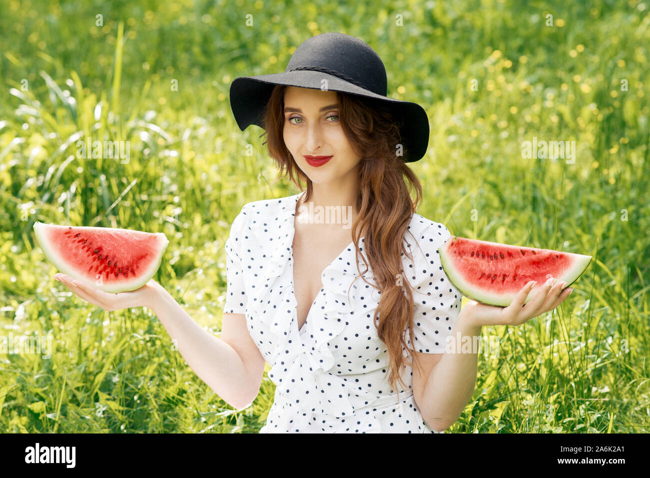 Attractive young girl is holding two slices of watermelon. Beautiful ...