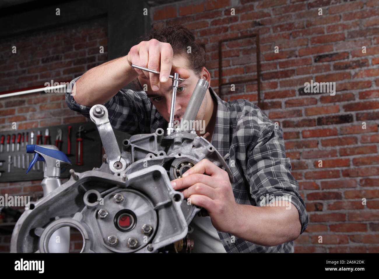 man work with the socket wrench, repair and cleaning engine parts on ...