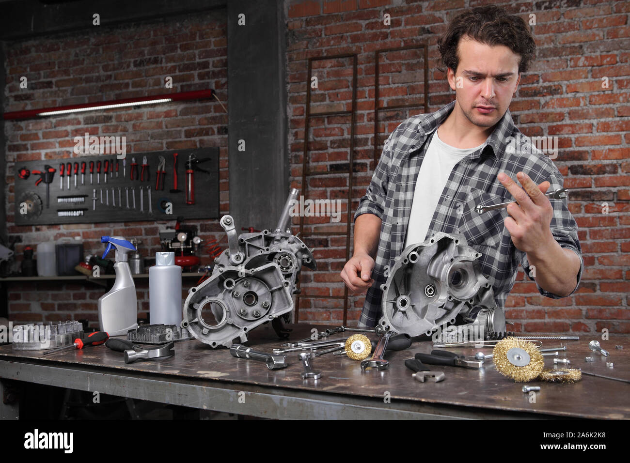 man work choose the wrench for repair and cleaning engine parts on the ...