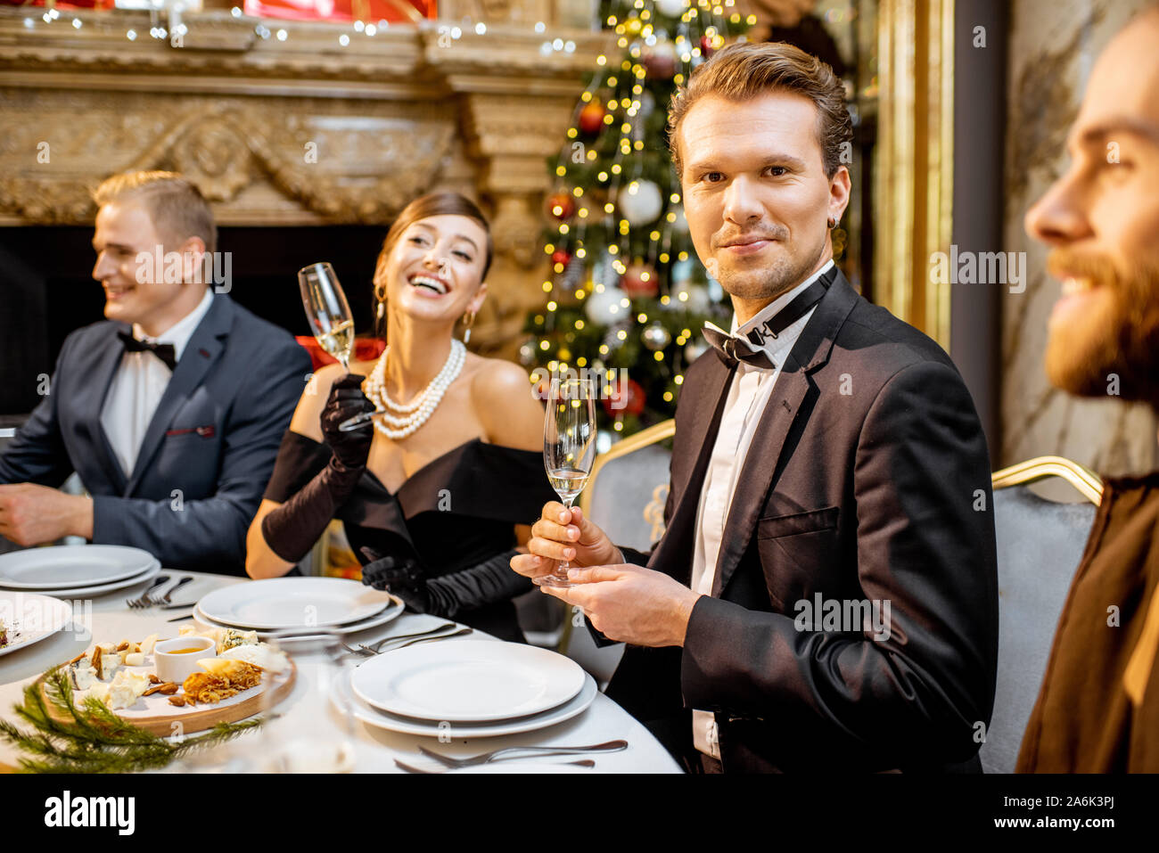 Portrait of a handsome well-dressed man sitting during a festive dinner ...
