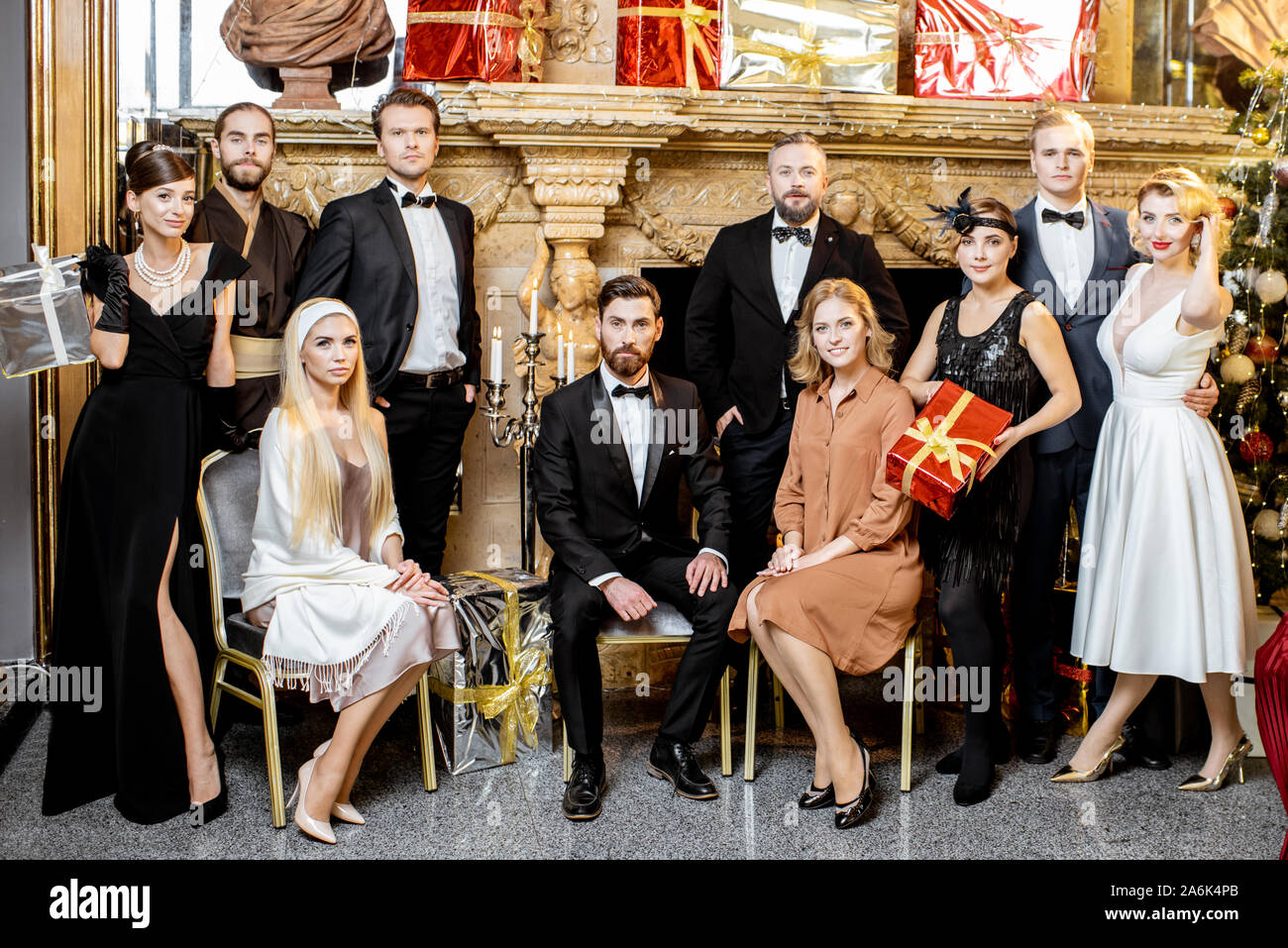 Staged group photo of an elegant well-dressed people near the ...