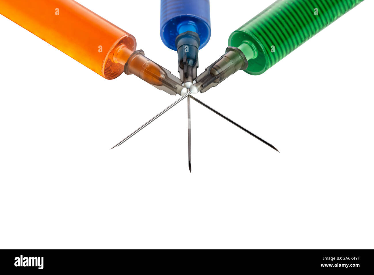 Three syringes filled with colorful liquids against isolated white ...