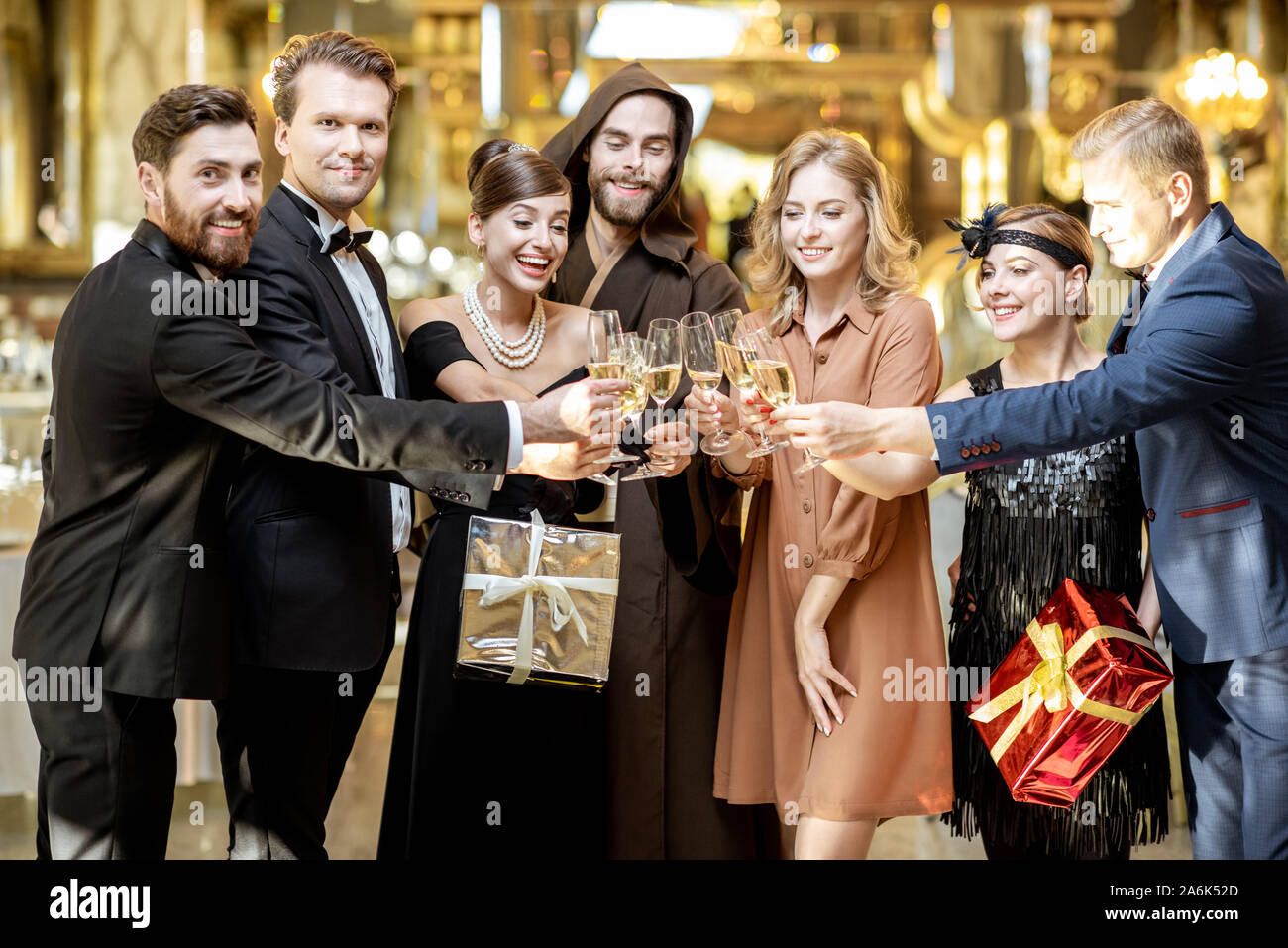 Group of elegant people well-dressed in retro styles celebrating New ...