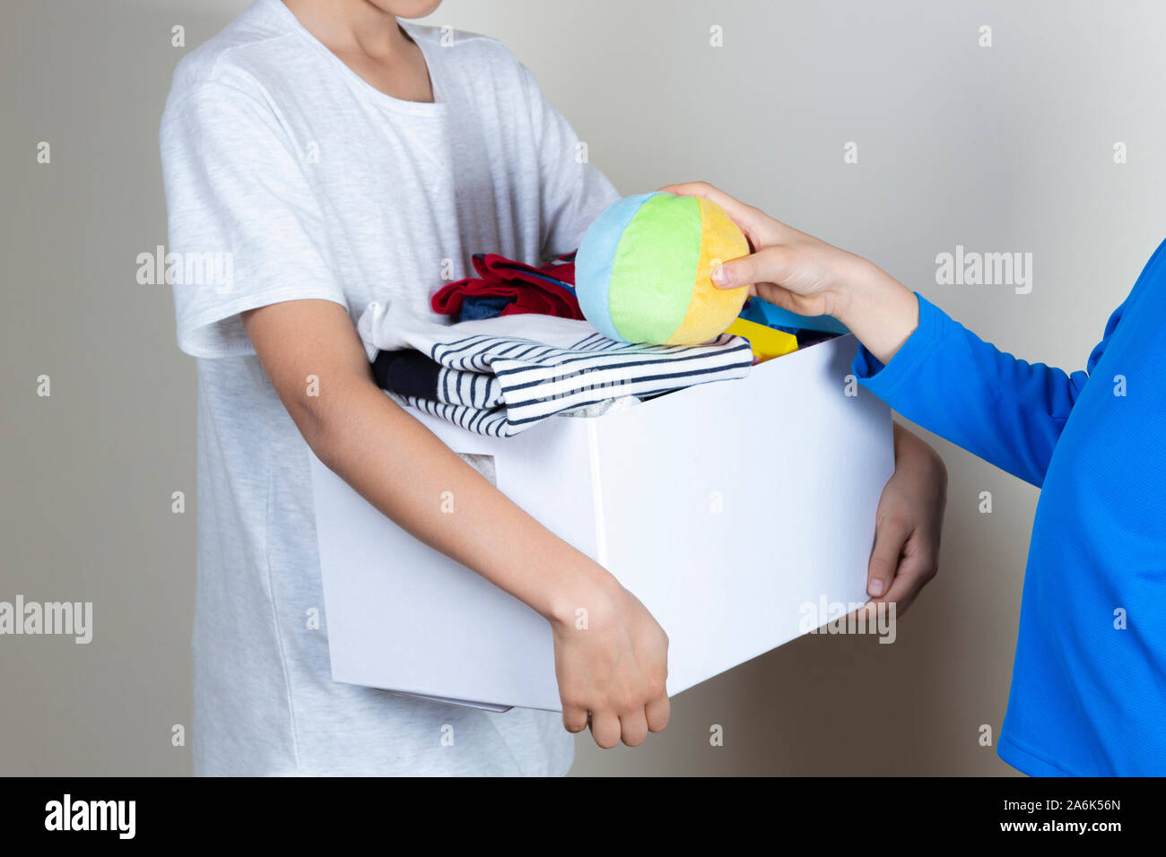 Donation concept. Kid hands collect donate box. Donation cardboard full ... Donation concept. Kid hands collect donate box. Donation cardboard full ...