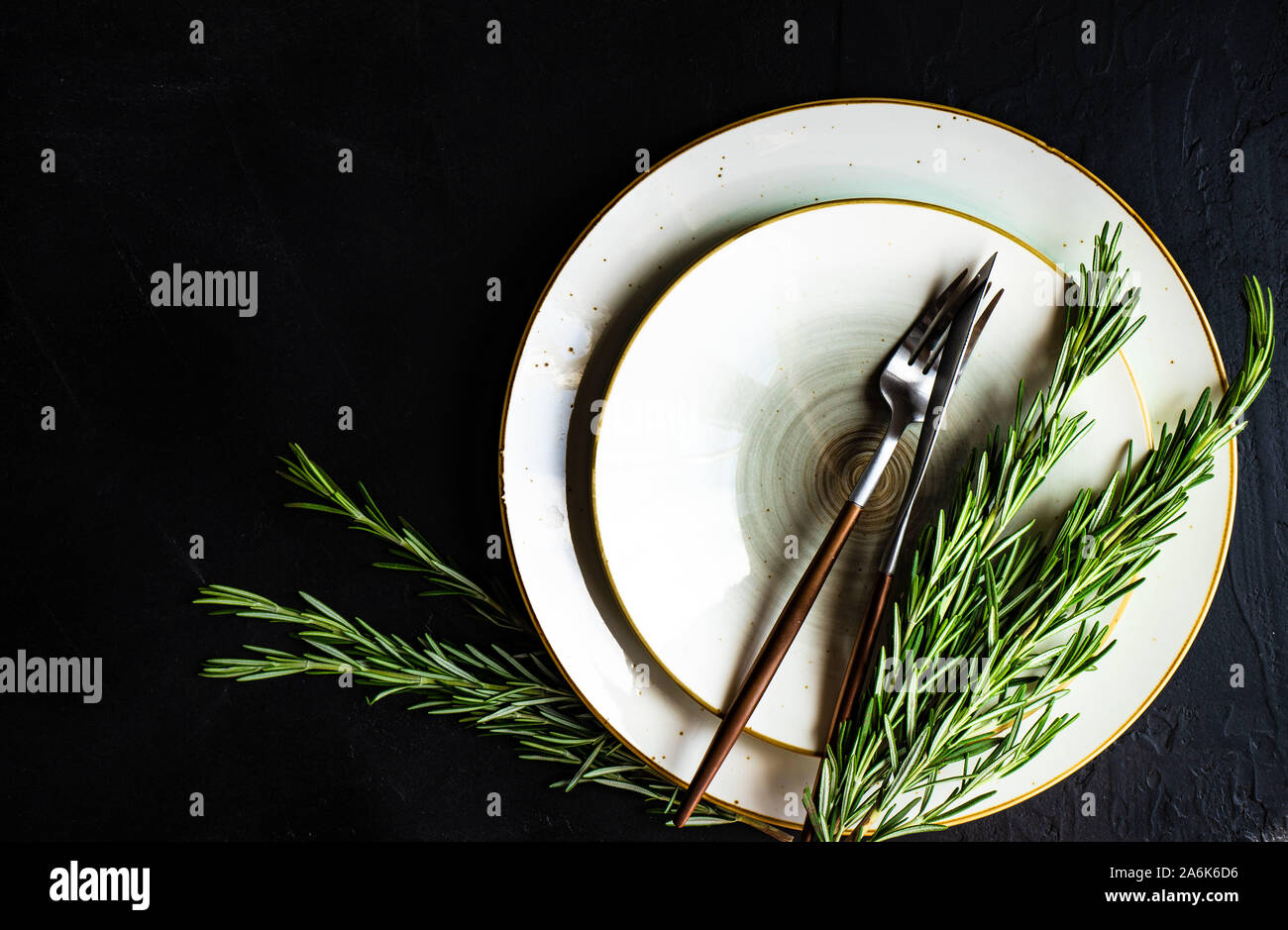 Rustic table setting with cutlery and plates decorated with fresh ...