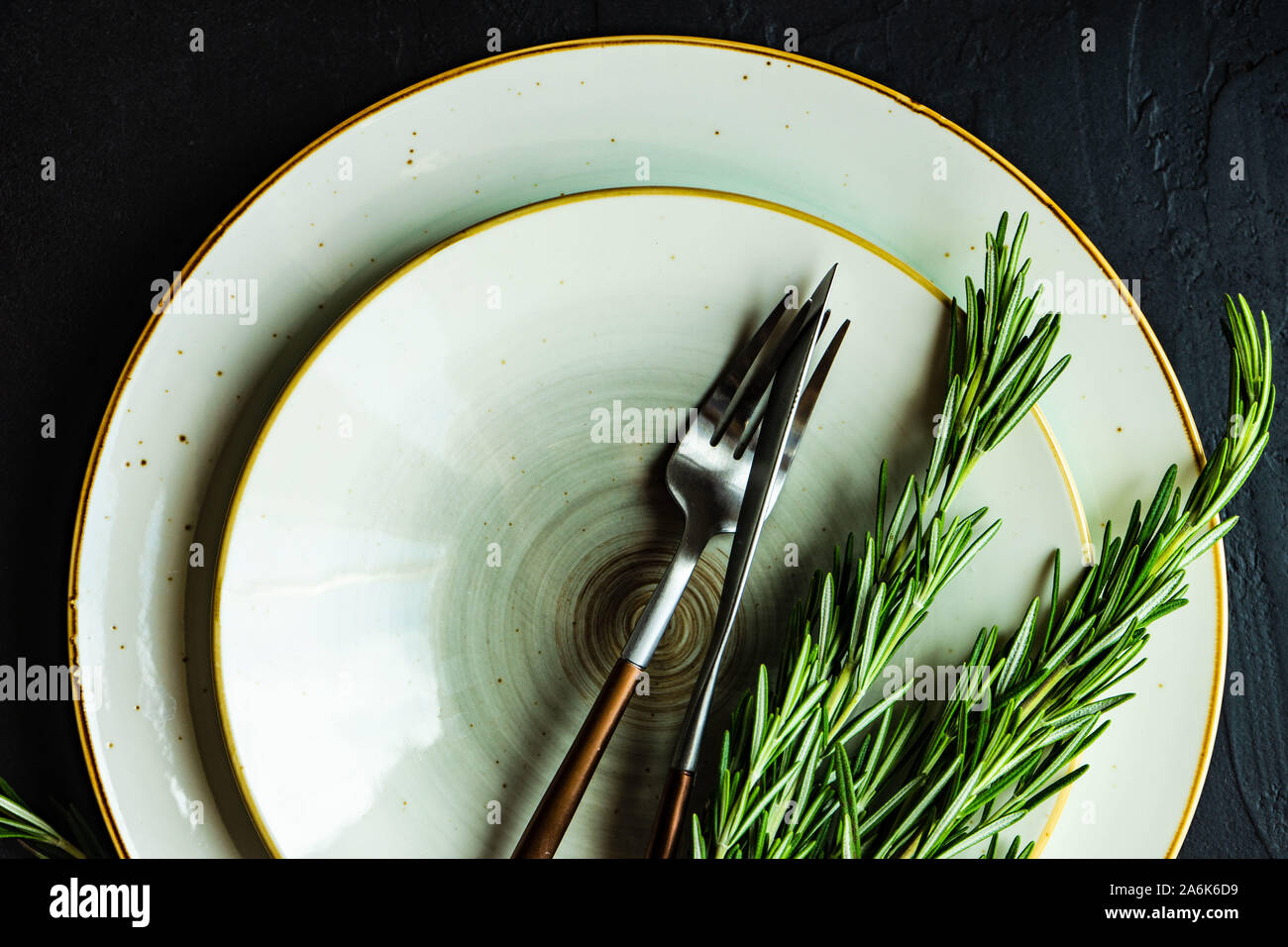 Rustic table setting with cutlery and plates decorated with fresh ...
