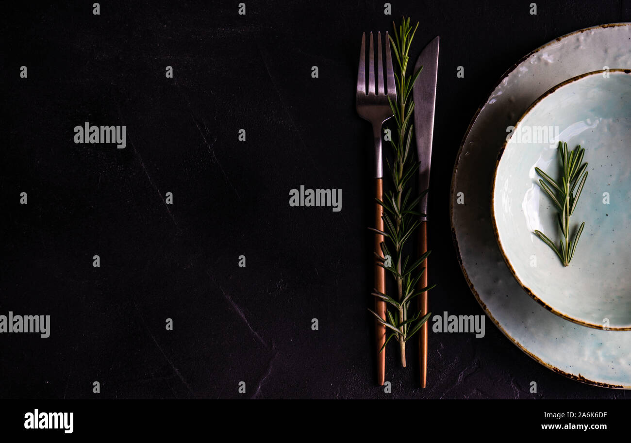 Rustic table setting with cutlery and plates decorated with fresh ...
